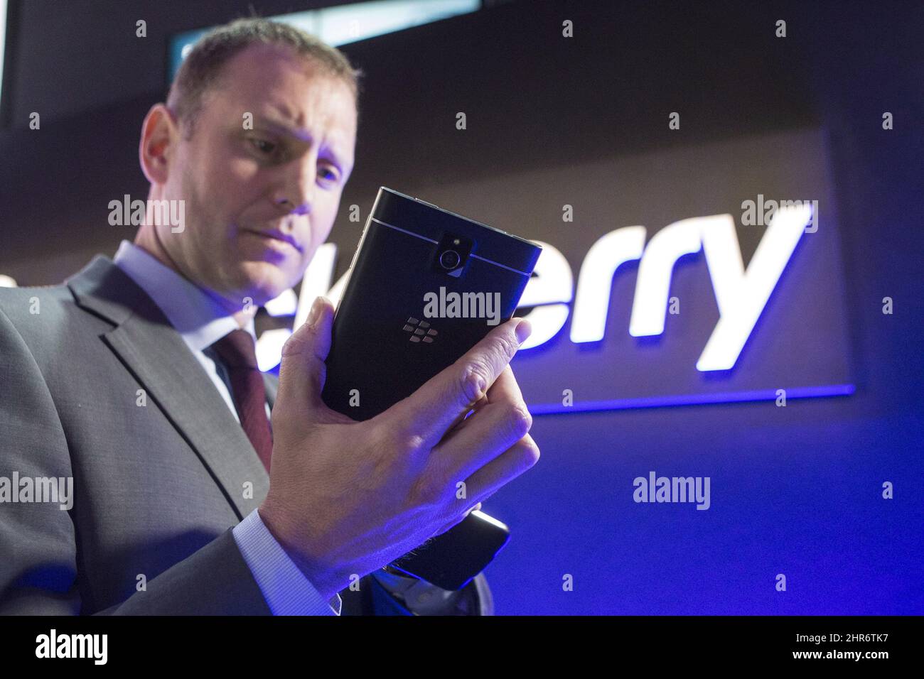 A journalist takes a look at the new BlackBerry Passport device at the ...
