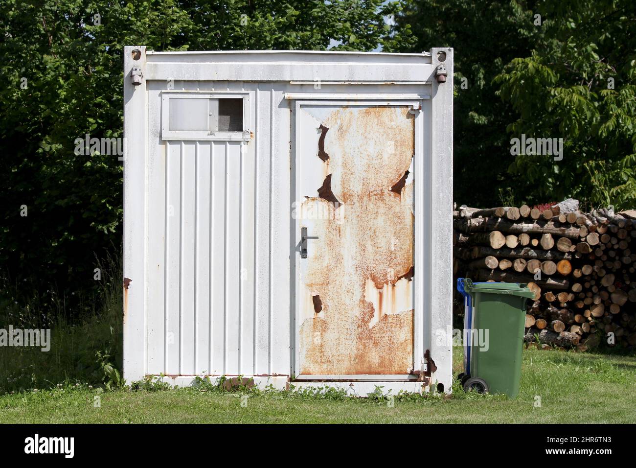 Front view of white old abandoned industrial shipping container ...