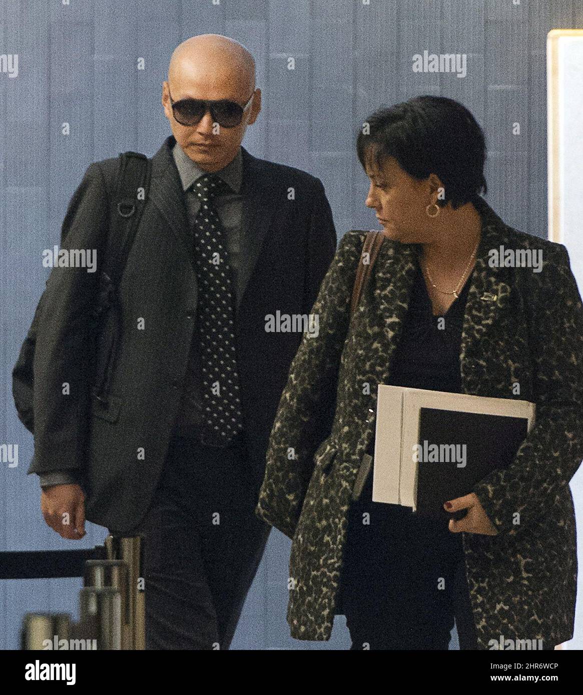 Feng Lin, left, a boyfriend of victim Jun Lin, leaves the courtroom ...