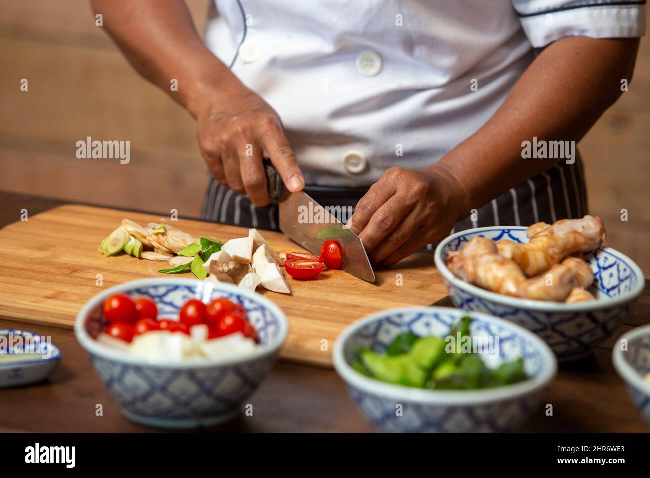Cooking process, woman cutting tomatoes for aubergine paste from ...