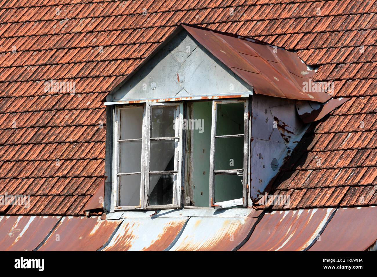 Large old damaged roof window with destroyed cracked wooden window ...