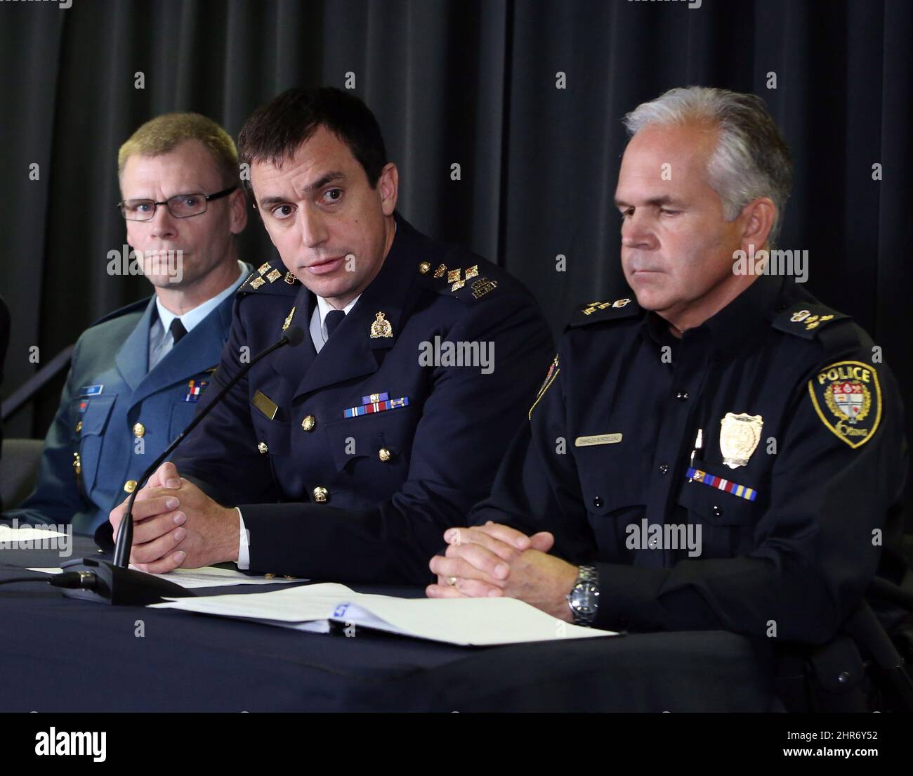 RCMP Assistant Commissioner Gilles Michaud (centre) holds a news ...