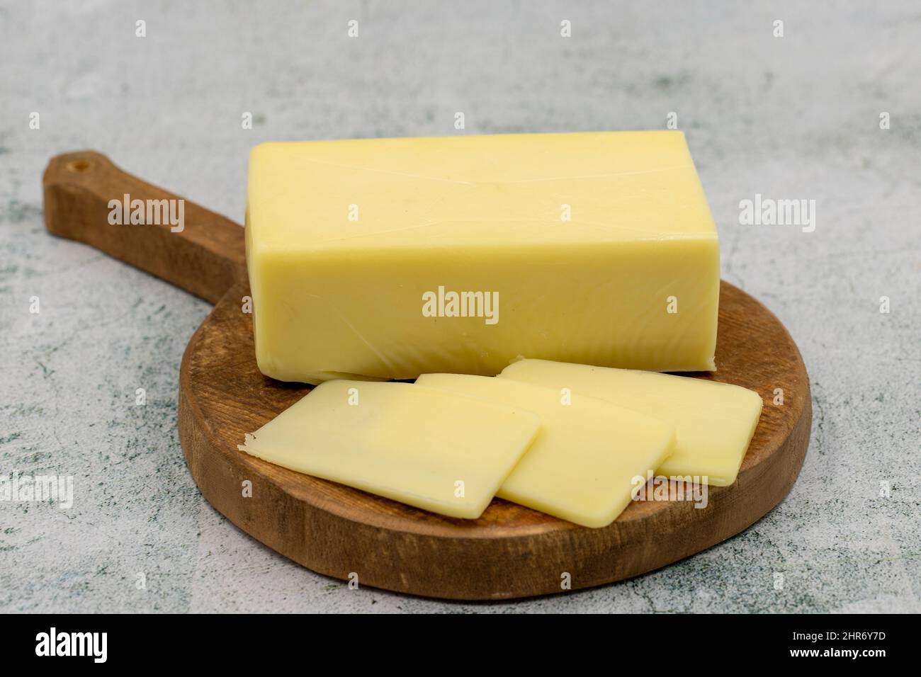 Kashar cheese or kashkaval cheese on stone background. Sliced Cheddar ...