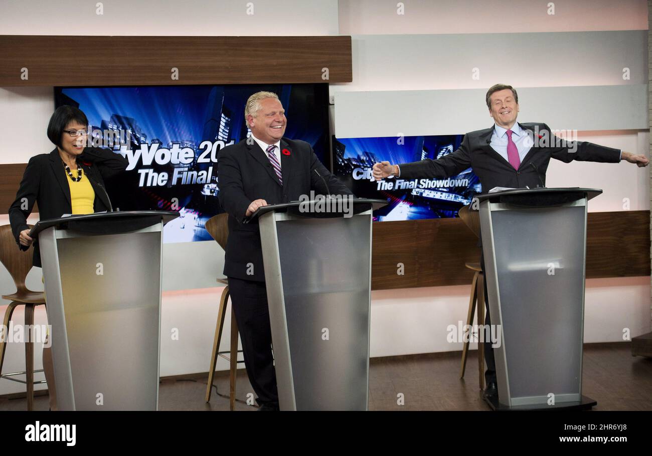 John Tory, right, reacts next to Doug Ford, centre, and Olivia Chow ...