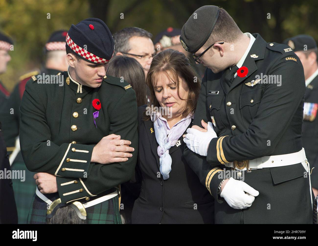 Kathy Cirillo is conforted by soldiers during the funeral procession ...