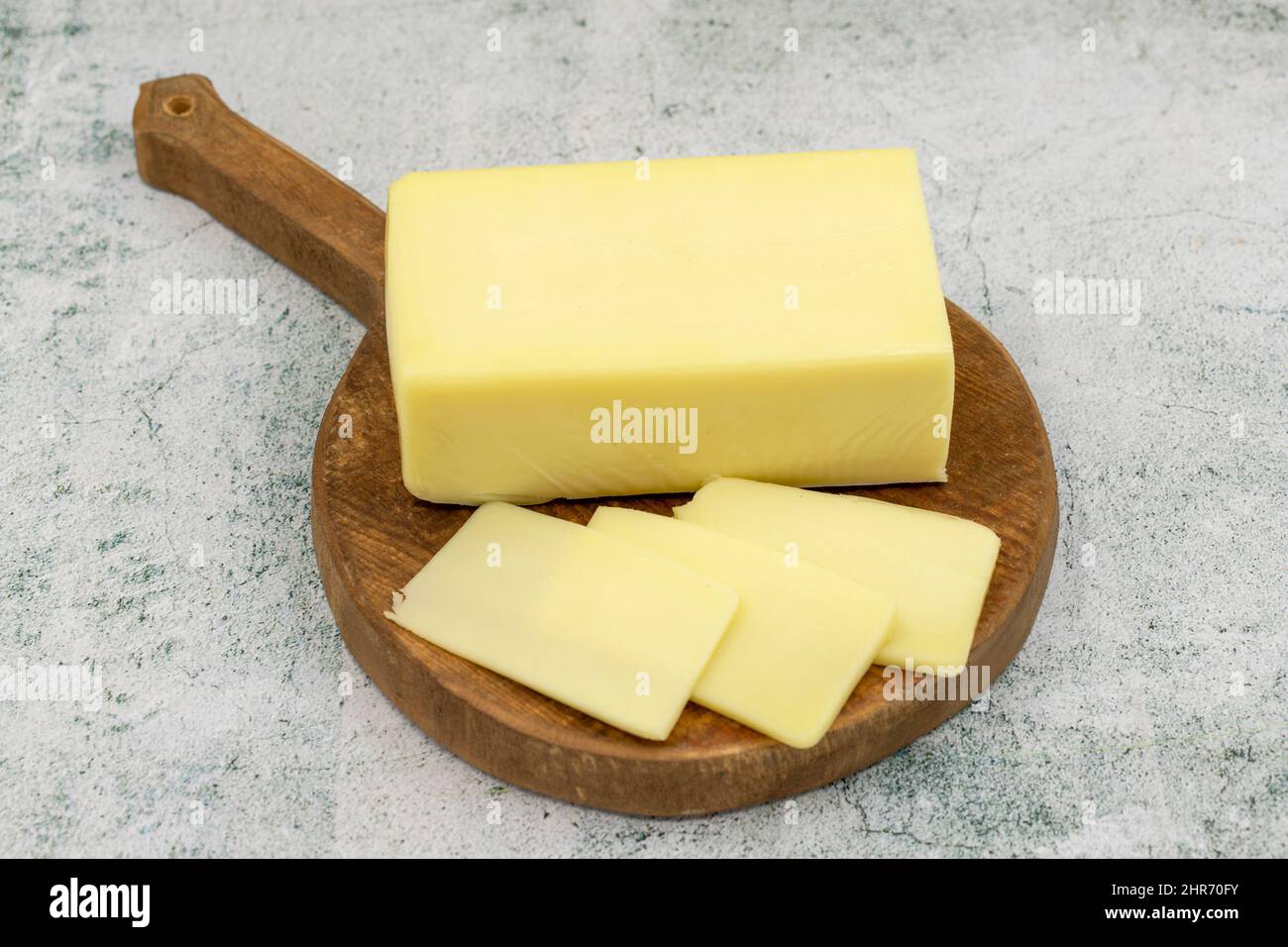 Kashar cheese or kashkaval cheese on stone background. Sliced Cheddar ...