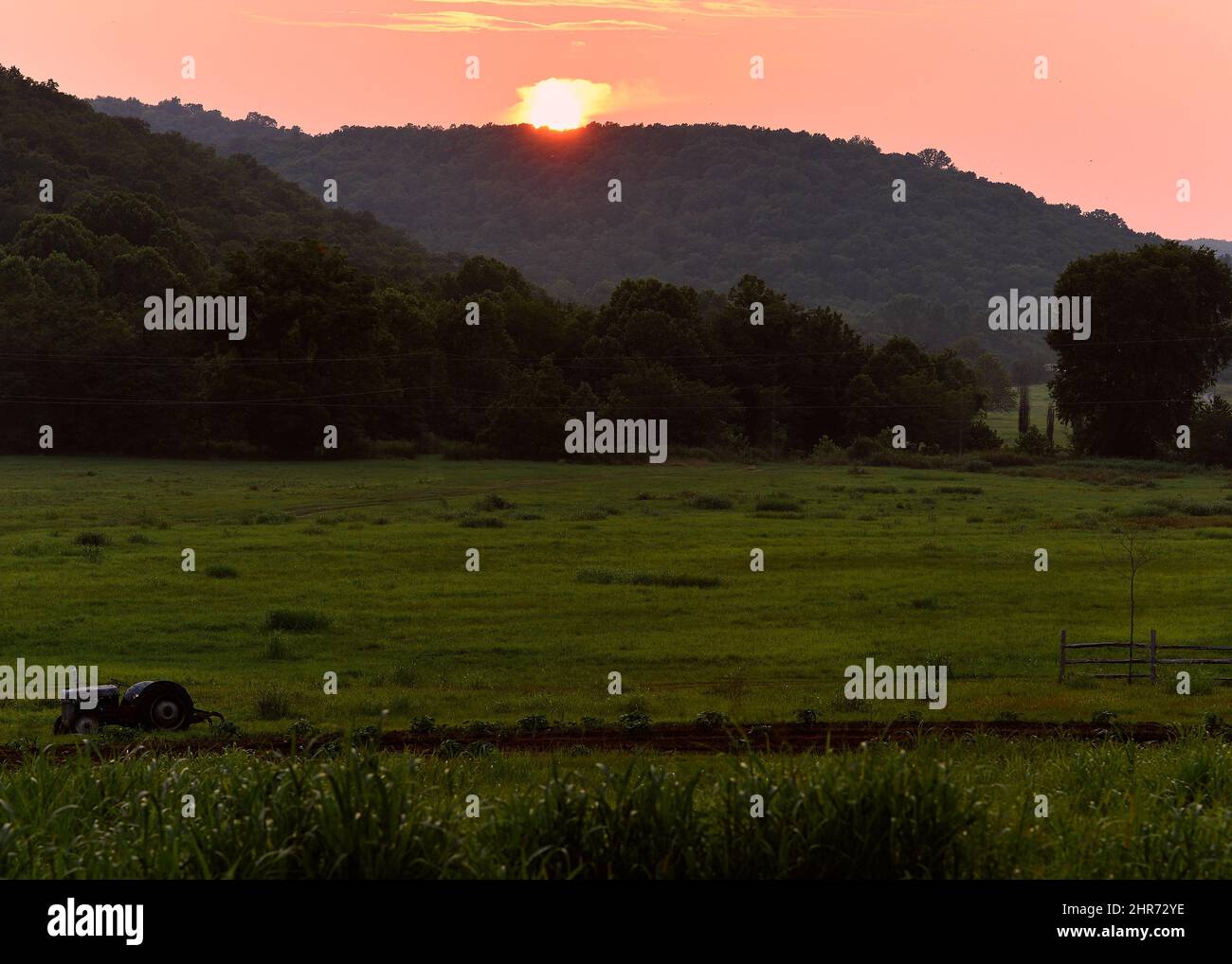 SUNSET BEHIND MOUNTAINS Stock Photo - Alamy