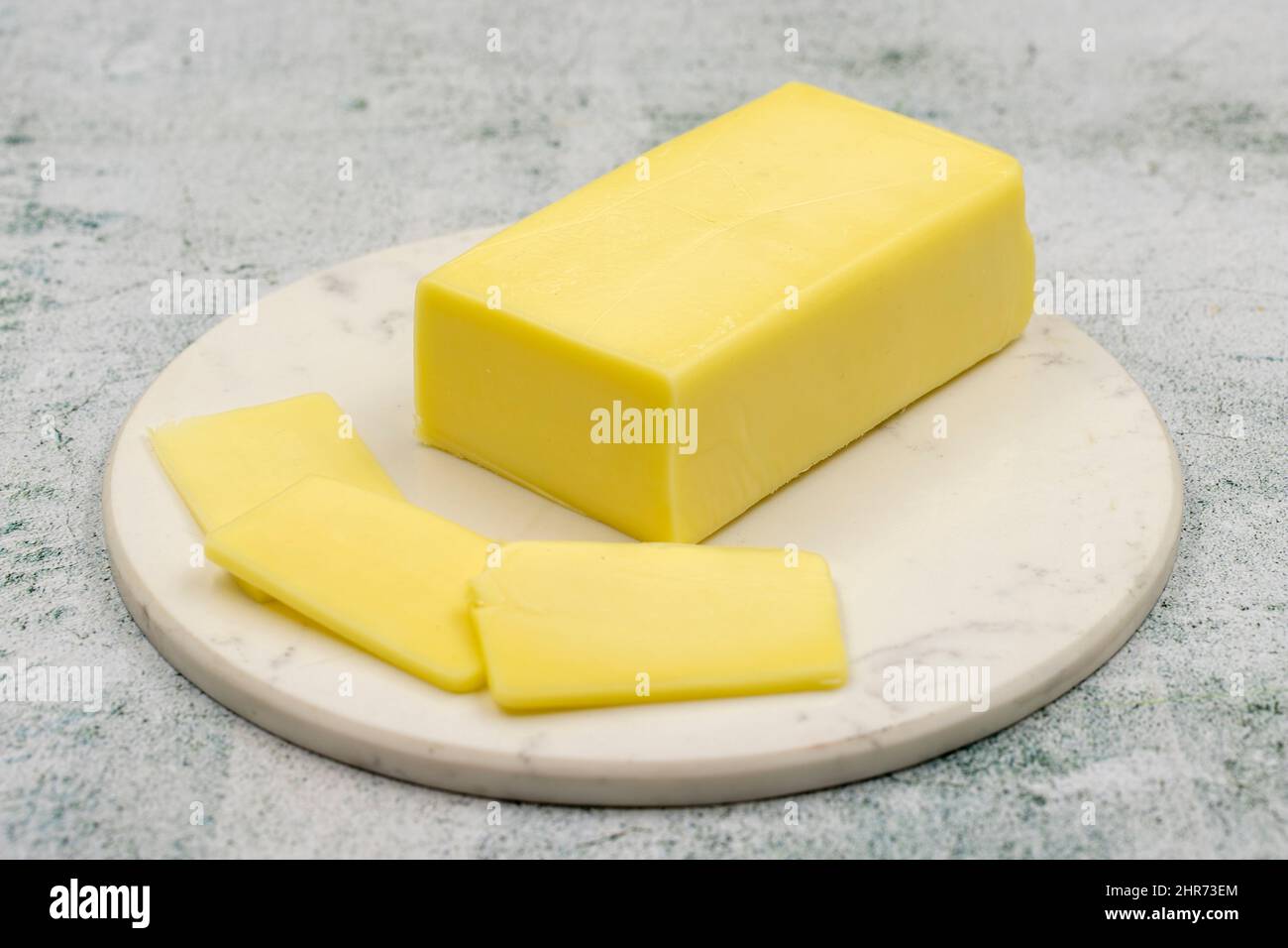 Kashar cheese or kashkaval cheese on stone background. Sliced Cheddar ...