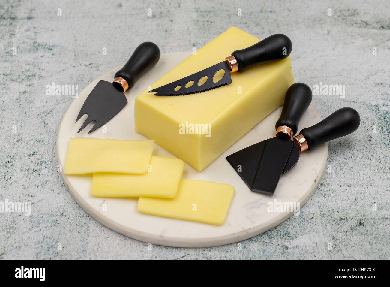 Kashar cheese or kashkaval cheese on stone background. Sliced Cheddar ...