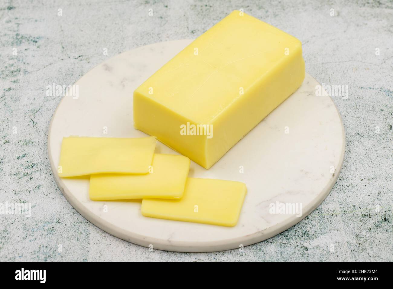 Kashar cheese or kashkaval cheese on stone background. Sliced Cheddar ...