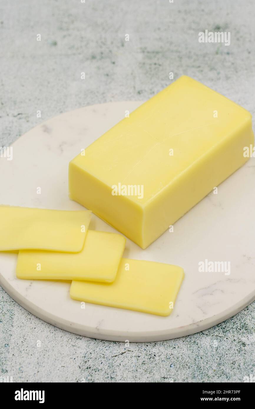 Kashar cheese or kashkaval cheese on stone background. Sliced Cheddar ...