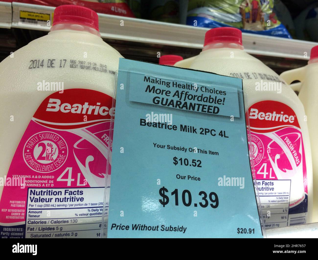 A price tag lists the price and subsidy of a 4 L jug of milk at a ...