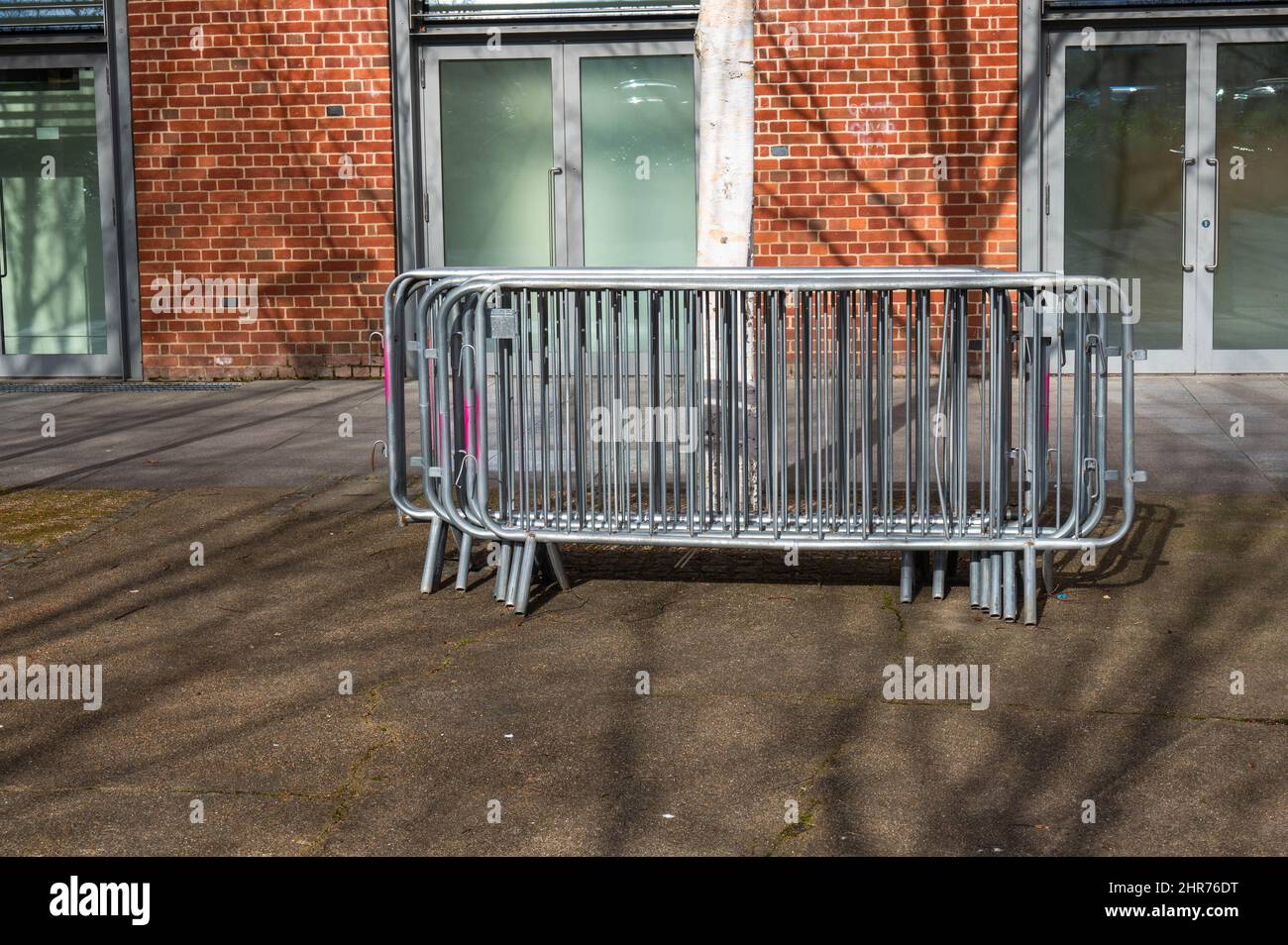 Stack of metal safety barriers stored next to a building in Norwich ...