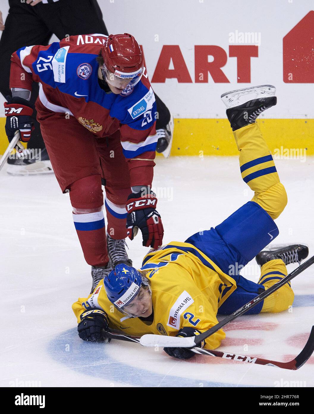 Russia Alexander Dergachyov (25) takes out Sweden defenceman Sebastian ...