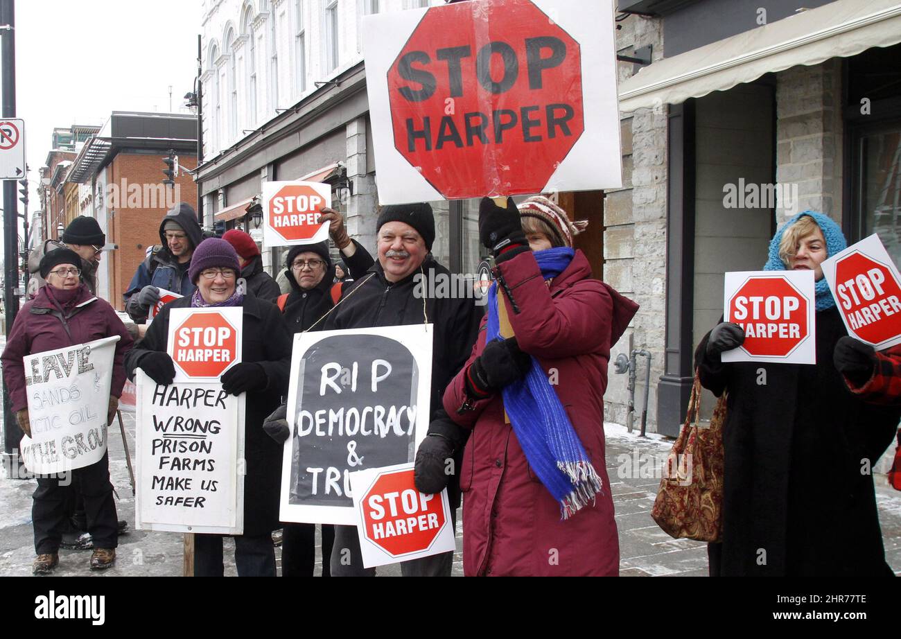 Protesters hold up Stop Harper signs outside Kingston City Hall, where ...