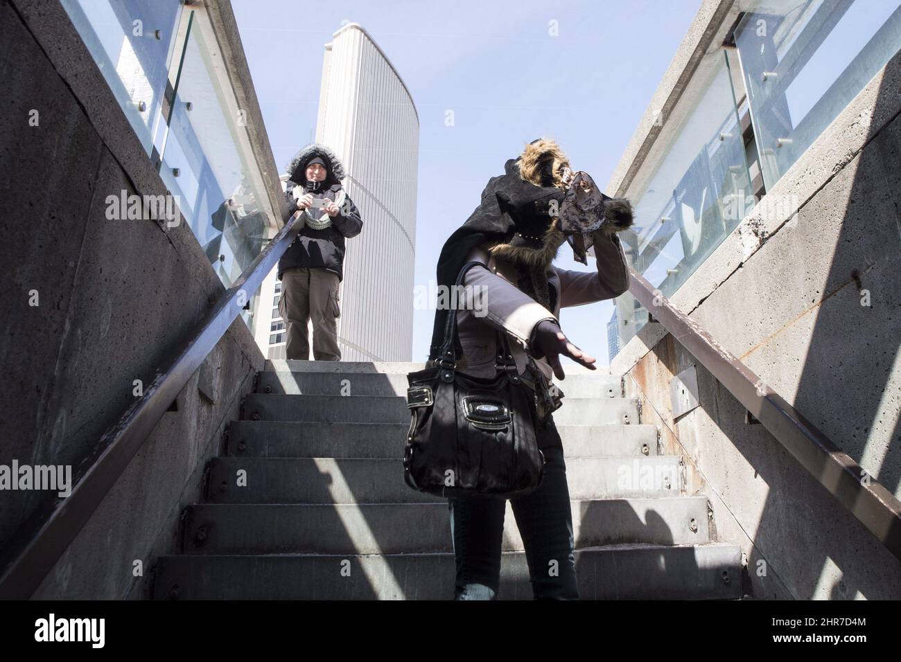 Elena Basso covers her face after leaving a Toronto court on Friday ...