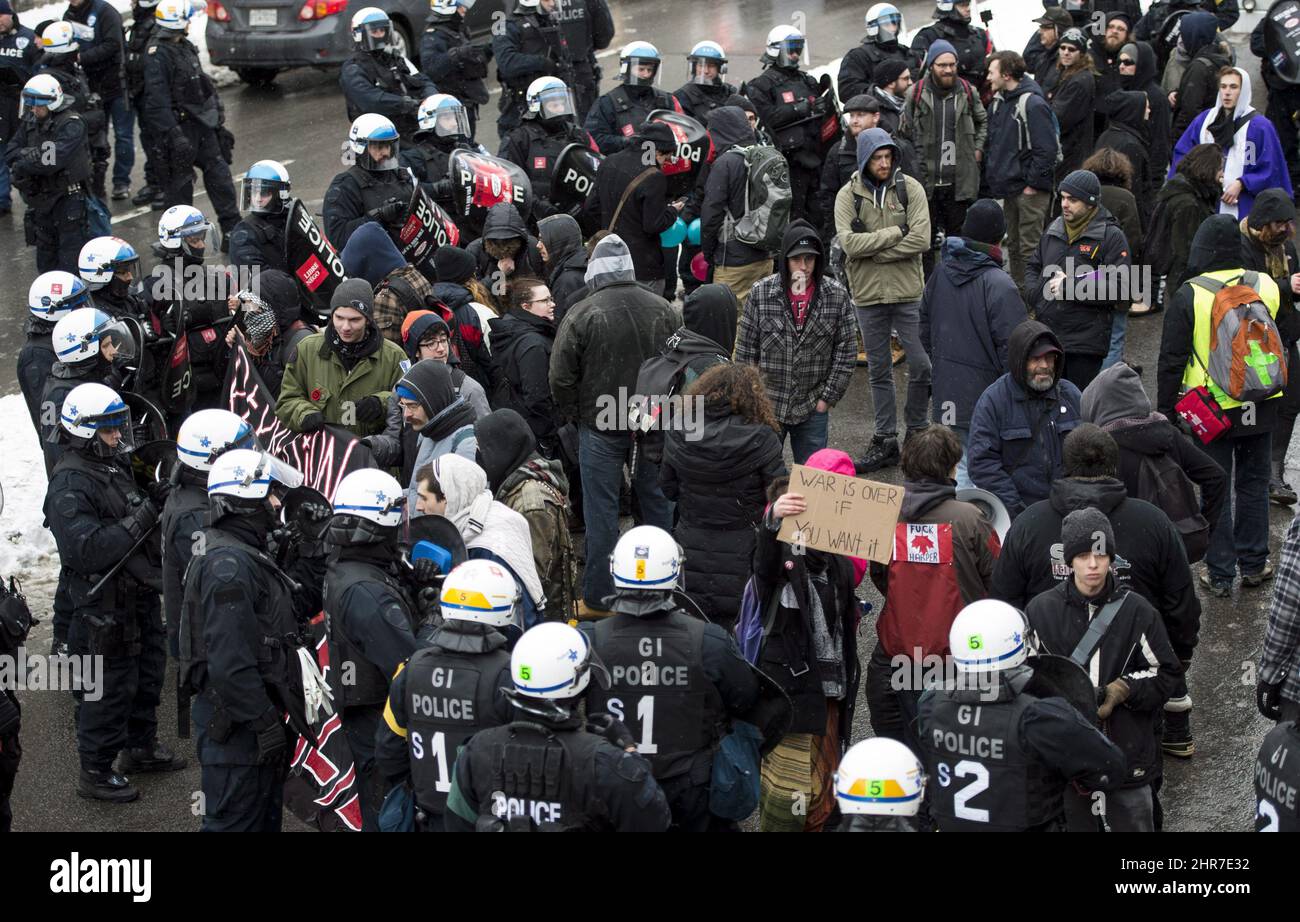 Demonstrators are surrounded by riot police during the annual anti ...
