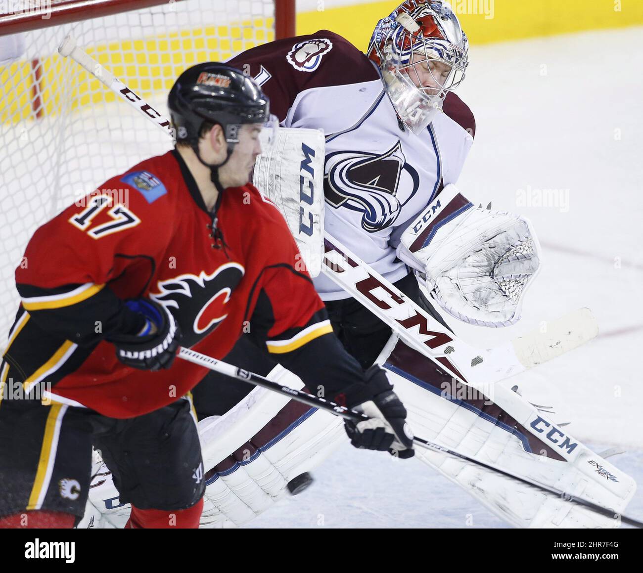 Calgary Flames' Lance Bouma, left, deflects the winning goal past ...