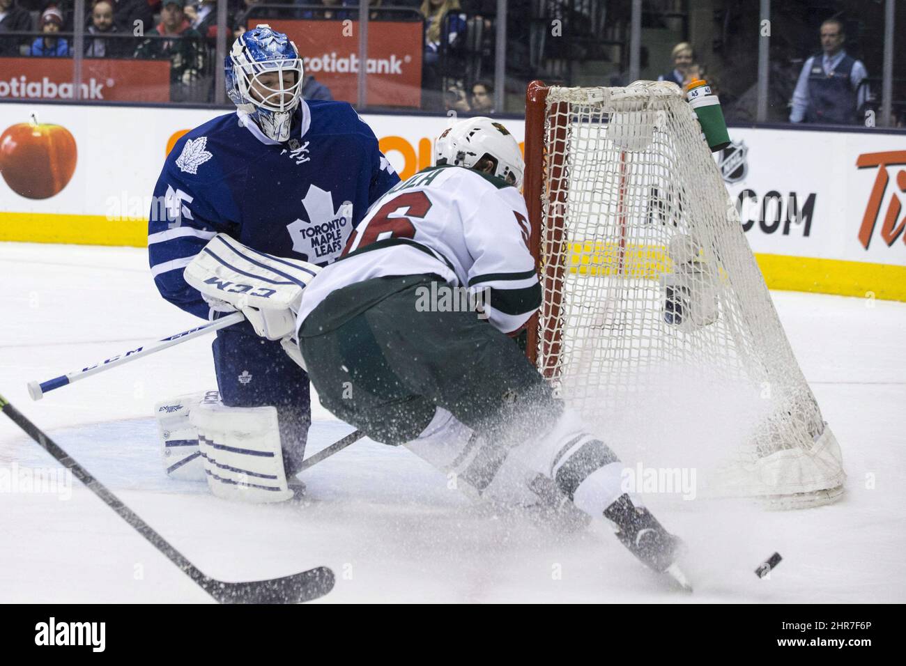 Toronto Maple Leafs goaltender Jonathan Bernier, left, makes a save in ...