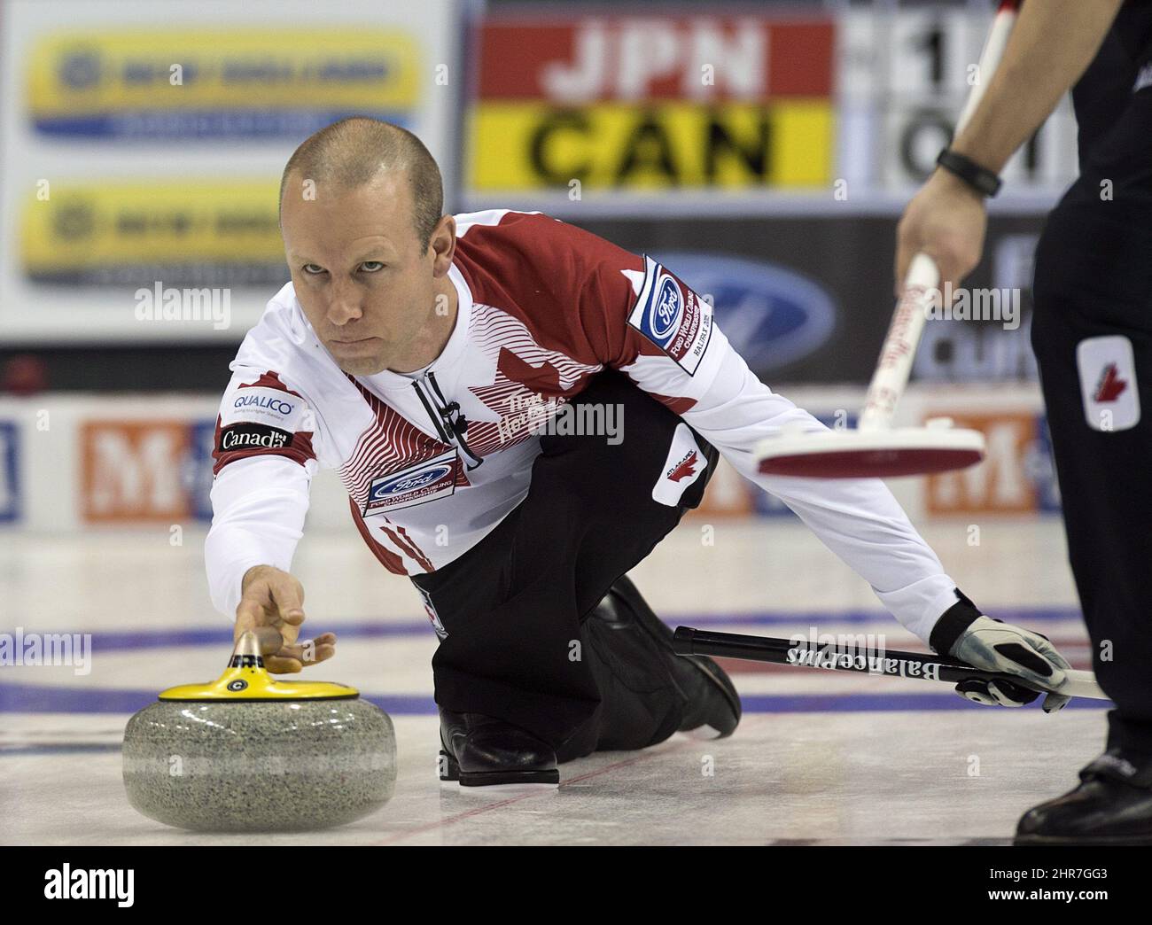 Team Canada skip Pat Simmons releases a rock as they play Japan at the ...