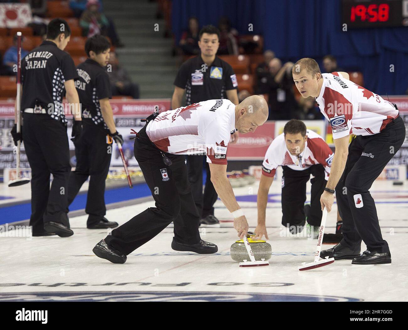 Team Canada's Nolan Thiessen, left, and Carter Rycroft, right, sweep a ...