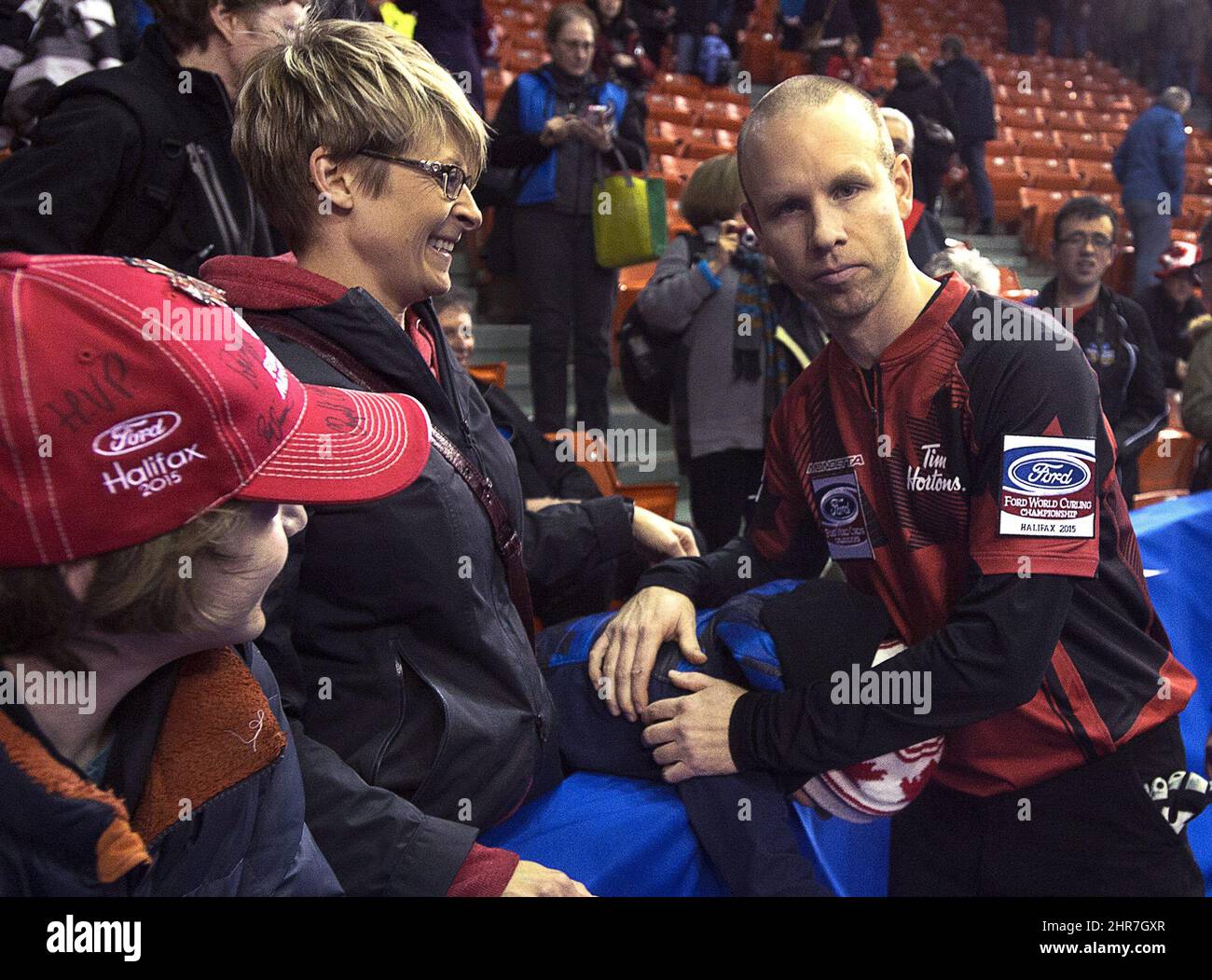 Team Canada skip Pat Simmons gets a hug from his son Max as he talks ...