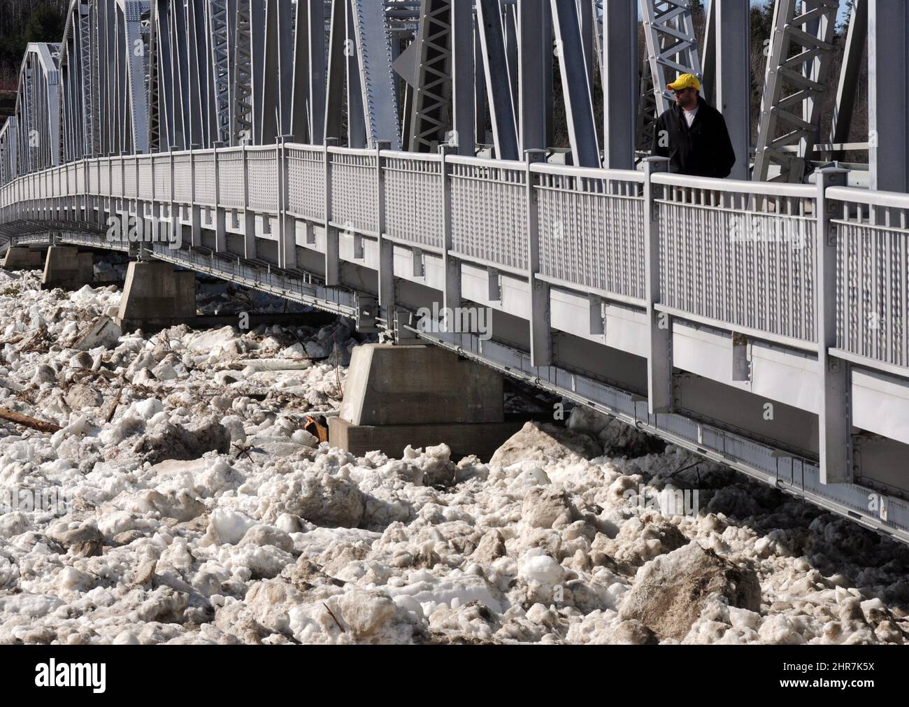 A man walks across the main bridge in the Village of Perth-Andover on ...