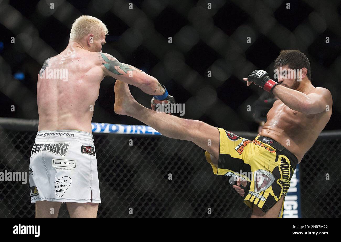 Patrick Cote, from Canada, right, lands a kick to the body of Joe Riggs ...