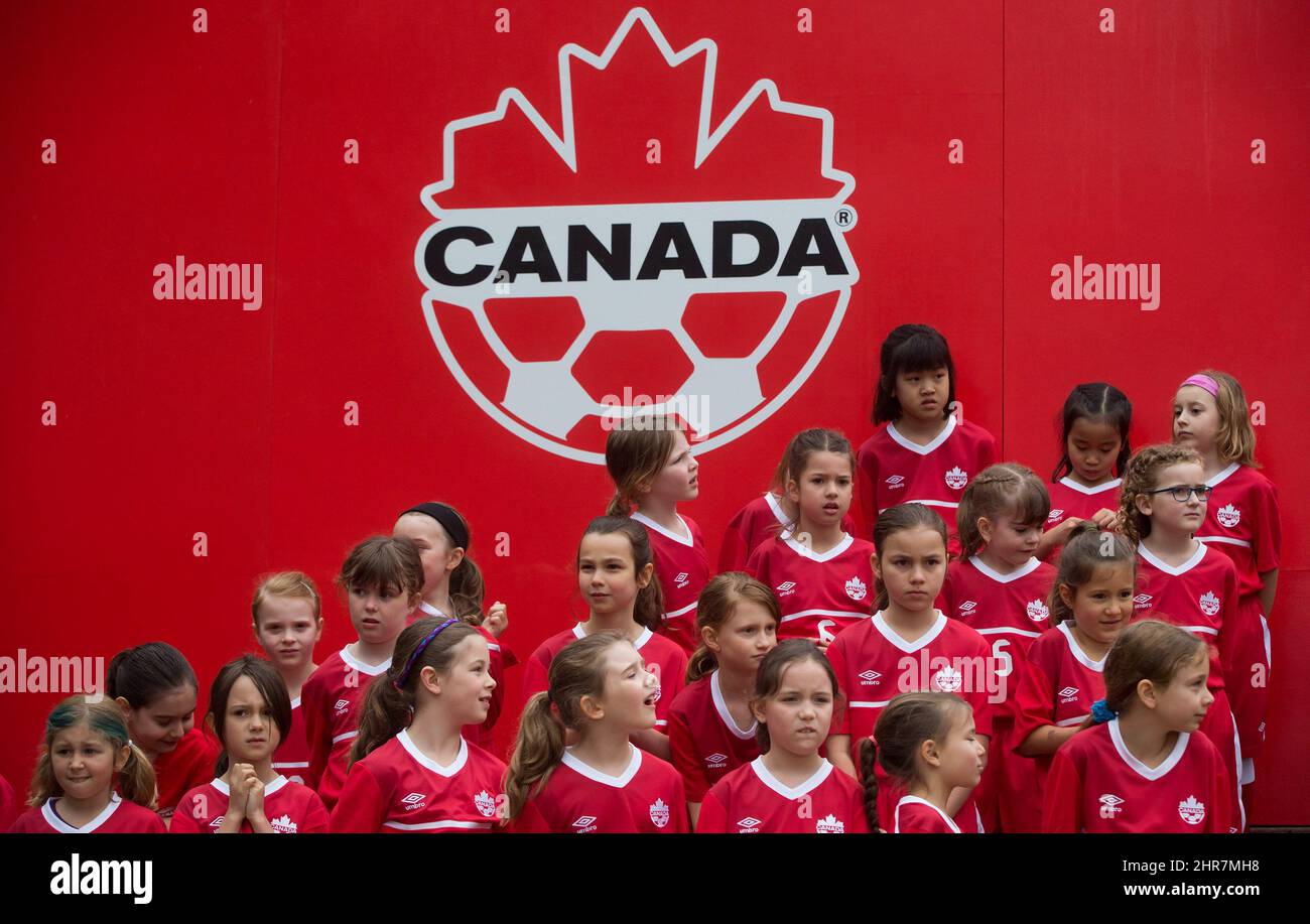 Young girls stand together during the announcement of the Canadian ...