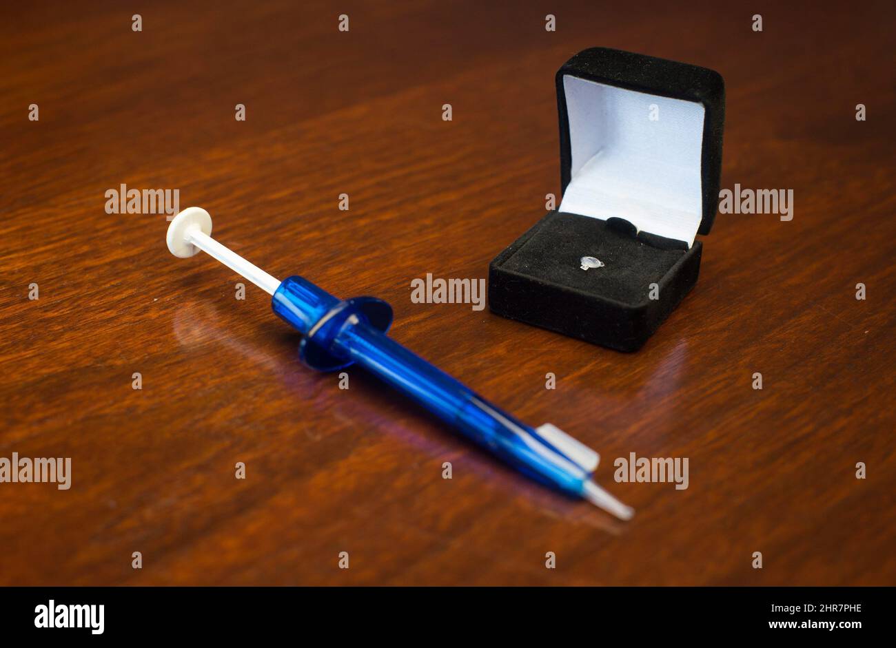 A bionic lens and an injector containing a cartridge developed by Dr. Garth Webb are seen at ...