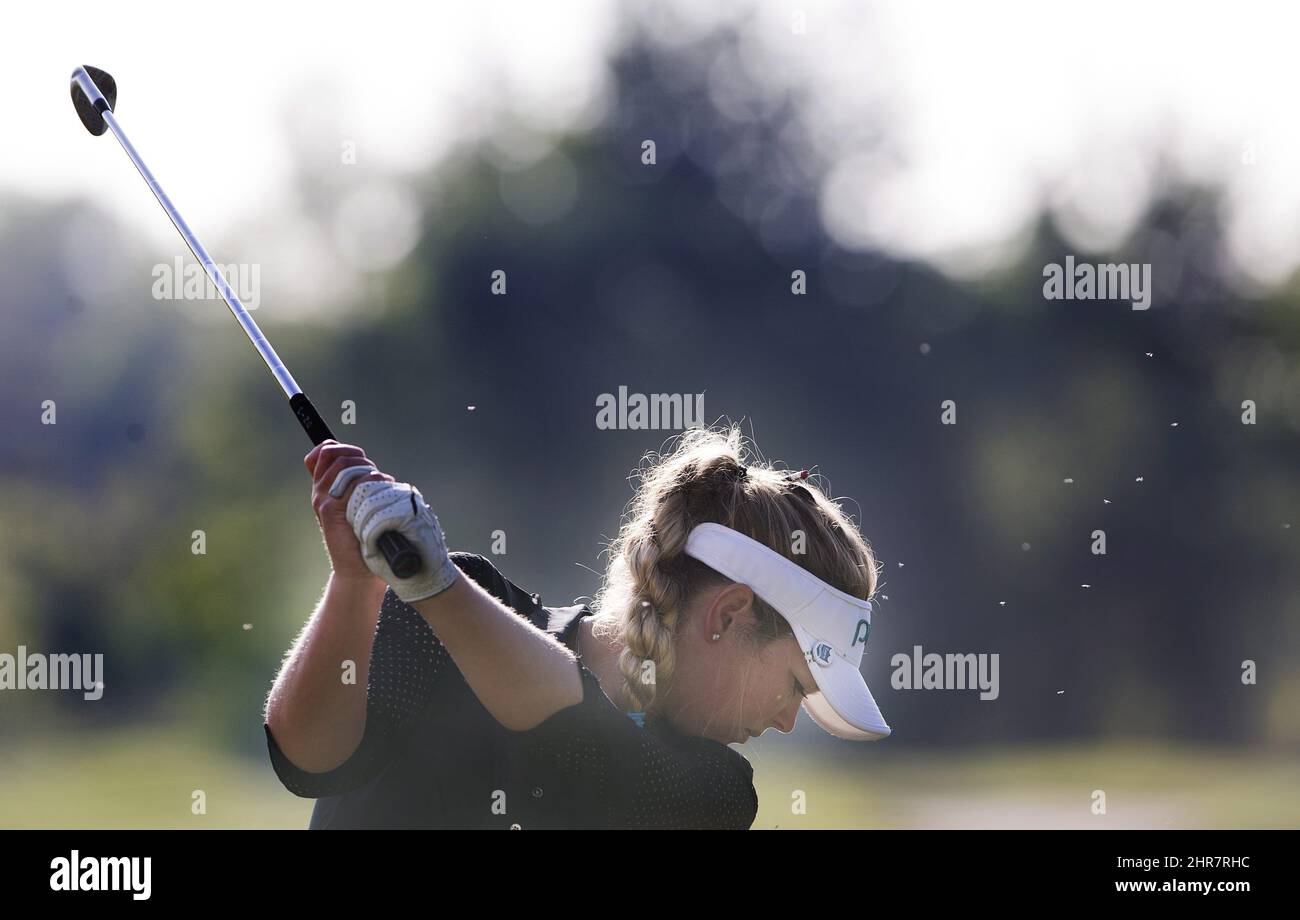 Brittany Henderson tries to concentrate on the range with flies buzzing ...