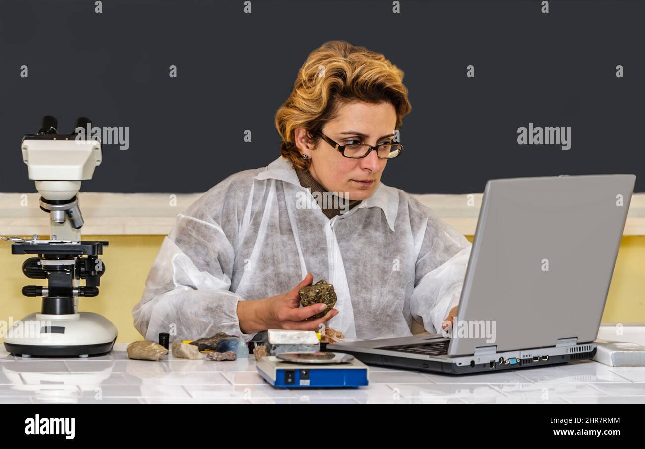 Female geologist researcher analysing a rock at her workplace Stock ...