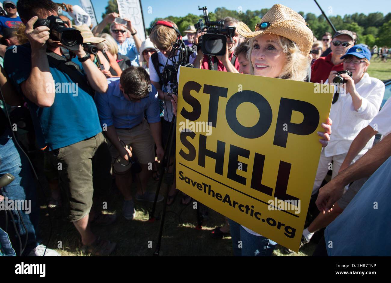 Actress Jane Fonda holds a "Stop Shell" sign during the "Toast the ...