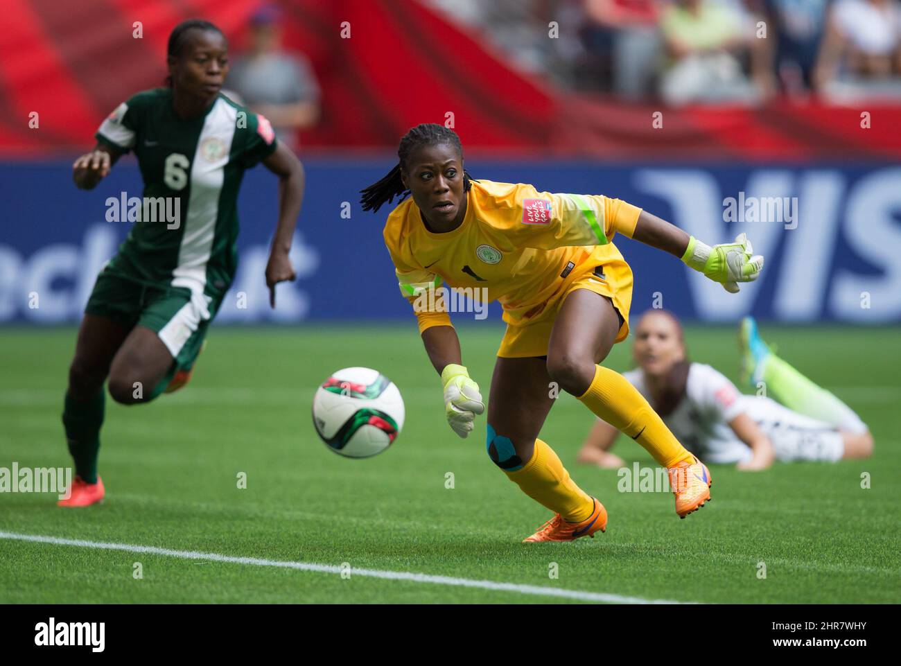 Nigeria goalkeeper Precious Dede, right, chases down the ball along ...