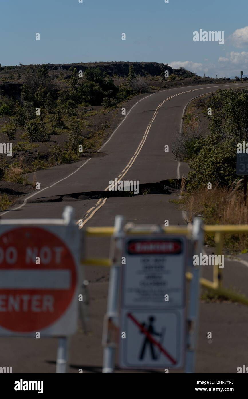 Vertical shot of a closed road with 'Do not enter' sign in a mountains ...