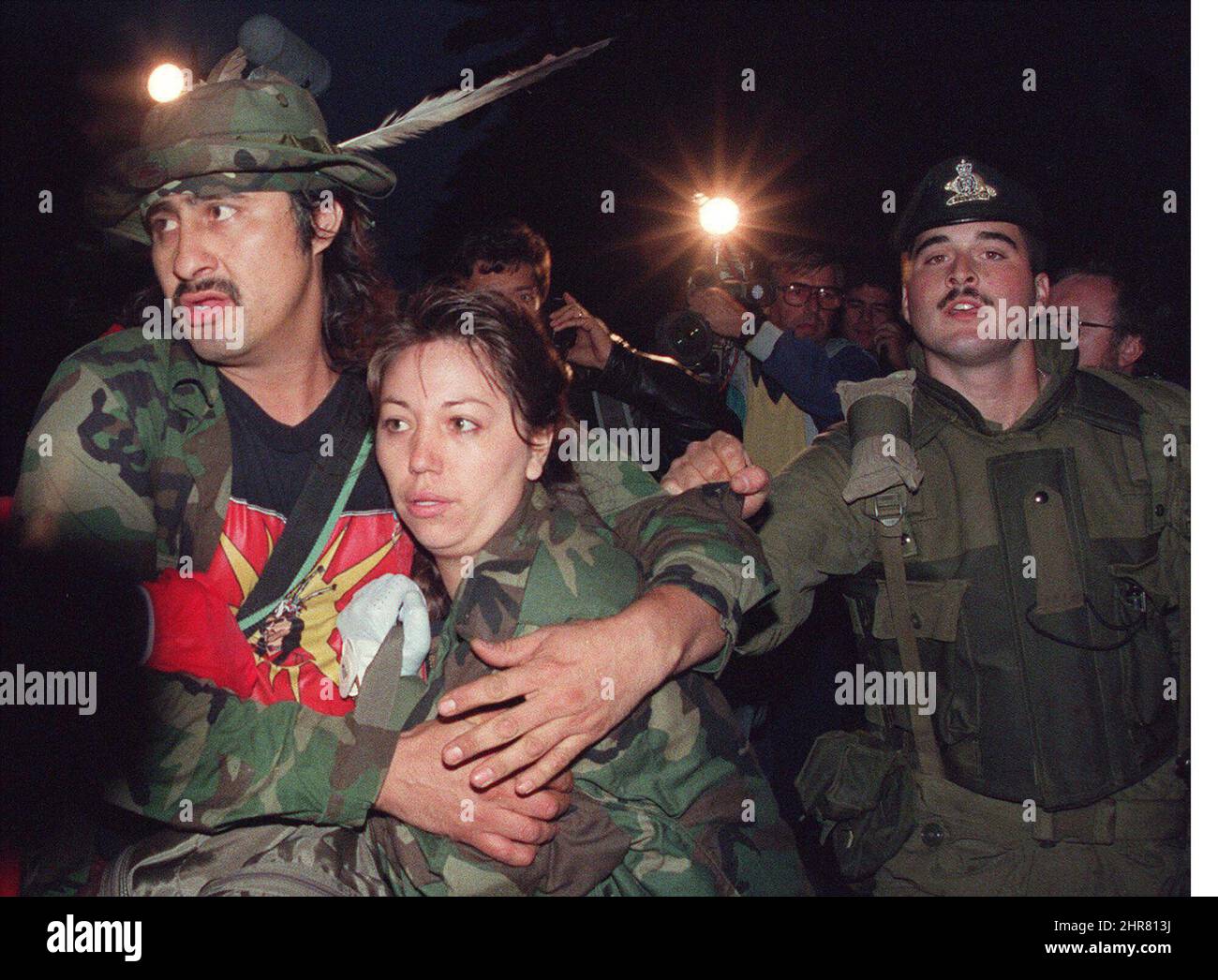 Mohawk Warrior known as Noreiga clutches a Mohawk woman as he is taken ...