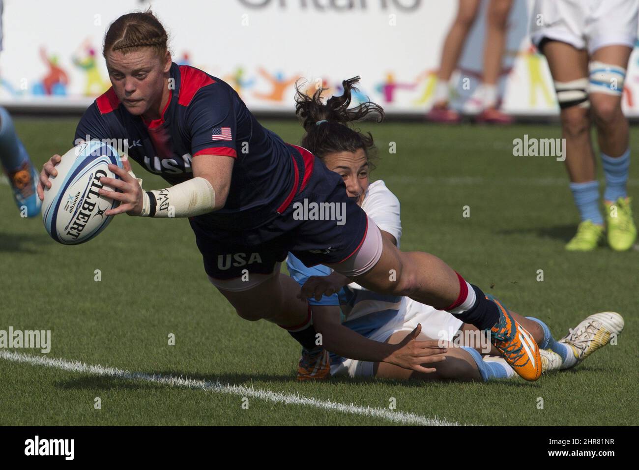 Team USA's Leyla Kelter (left) scores despite being tackled by ...