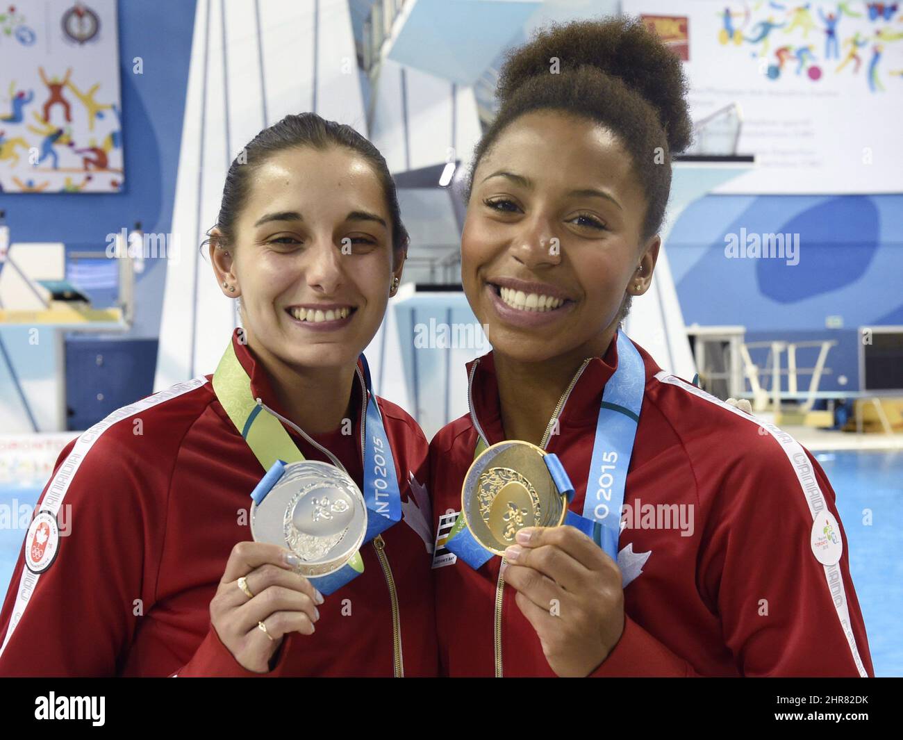 Pamela Ware, left, and Jennifer Abel of Canada smile and hold up their ...