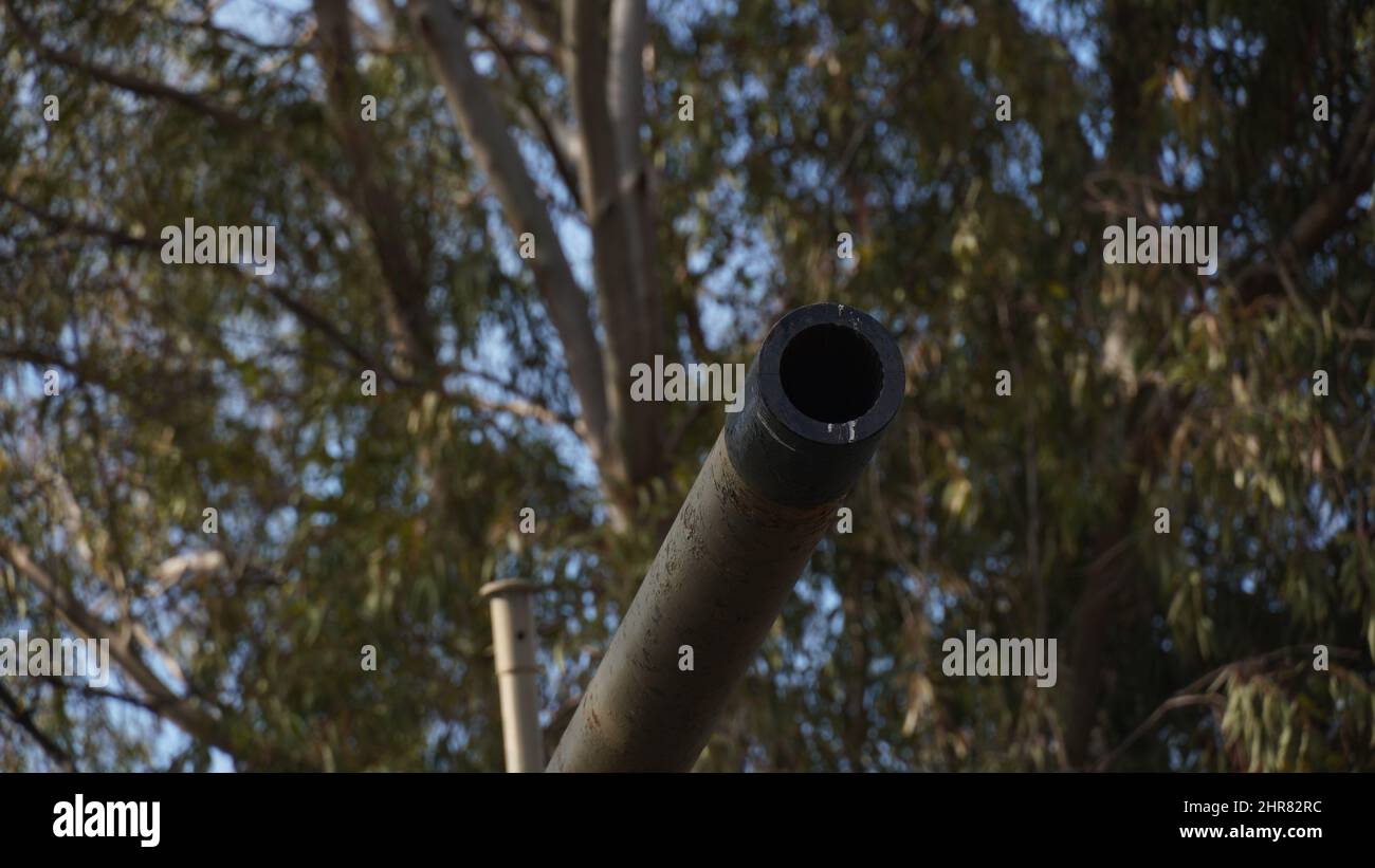 Picture of canon of a tank used in a war, looking into the barrel of ...