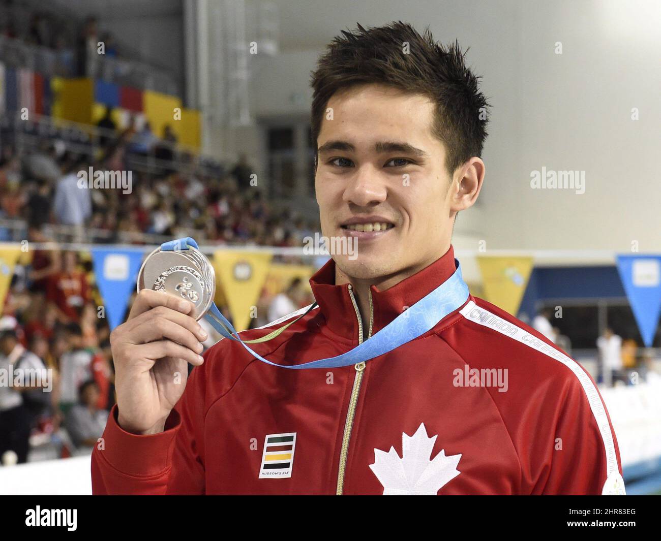 Richard Funk, of Canada, holds his silver medal after the men's 200 ...