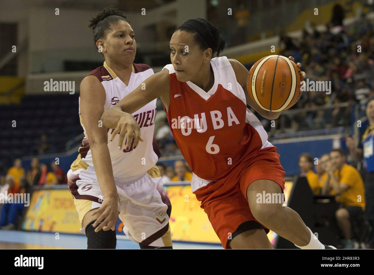 Cuba's Anisleidy Galindo, right, drives past Venezuela's Daniela Wallen ...