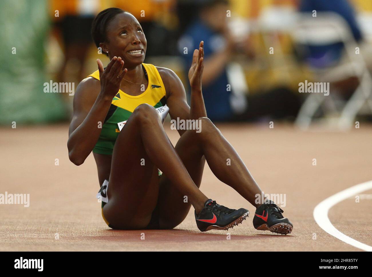 Sherone Simpson, of Jamaica, celebrates winning the gold medal in the ...