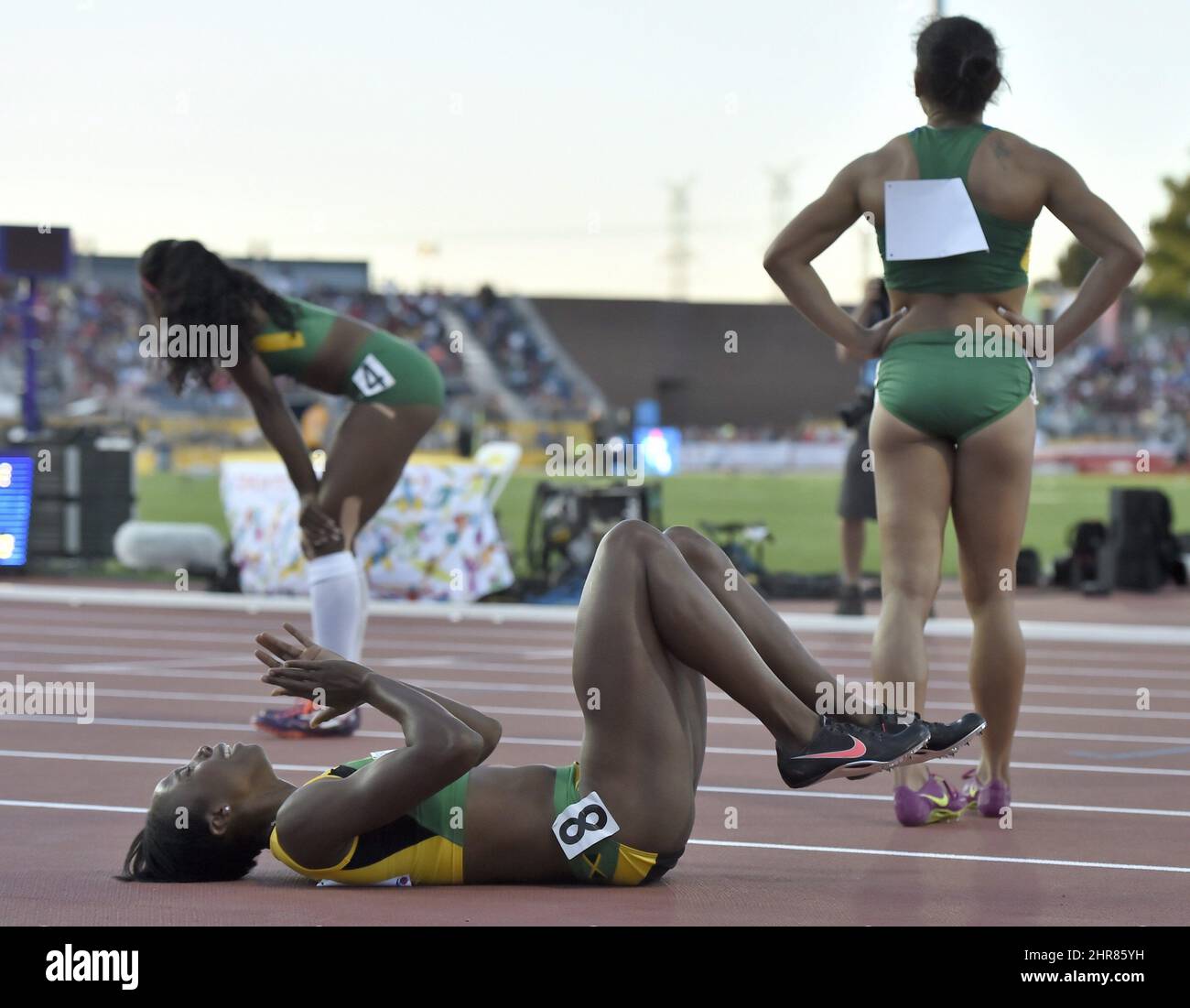 Sherone Simpson, of Jamaica, bottom, reacts after winning the gold ...