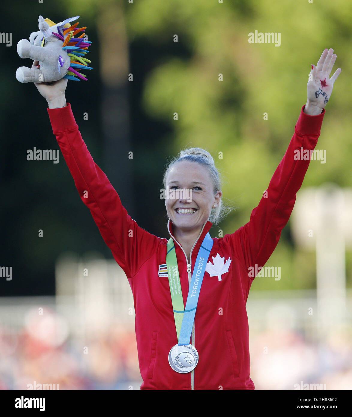 Sarah Wells, of Canada, waves to fans after winning the silver medal ...