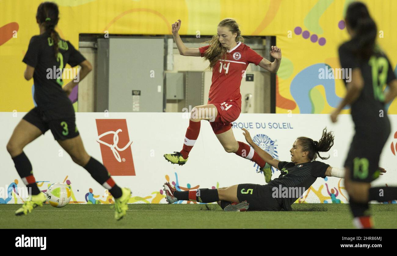 Canada's Gabrielle Carle (14) leaps over Mexico's Valeria Miranda (5 ...
