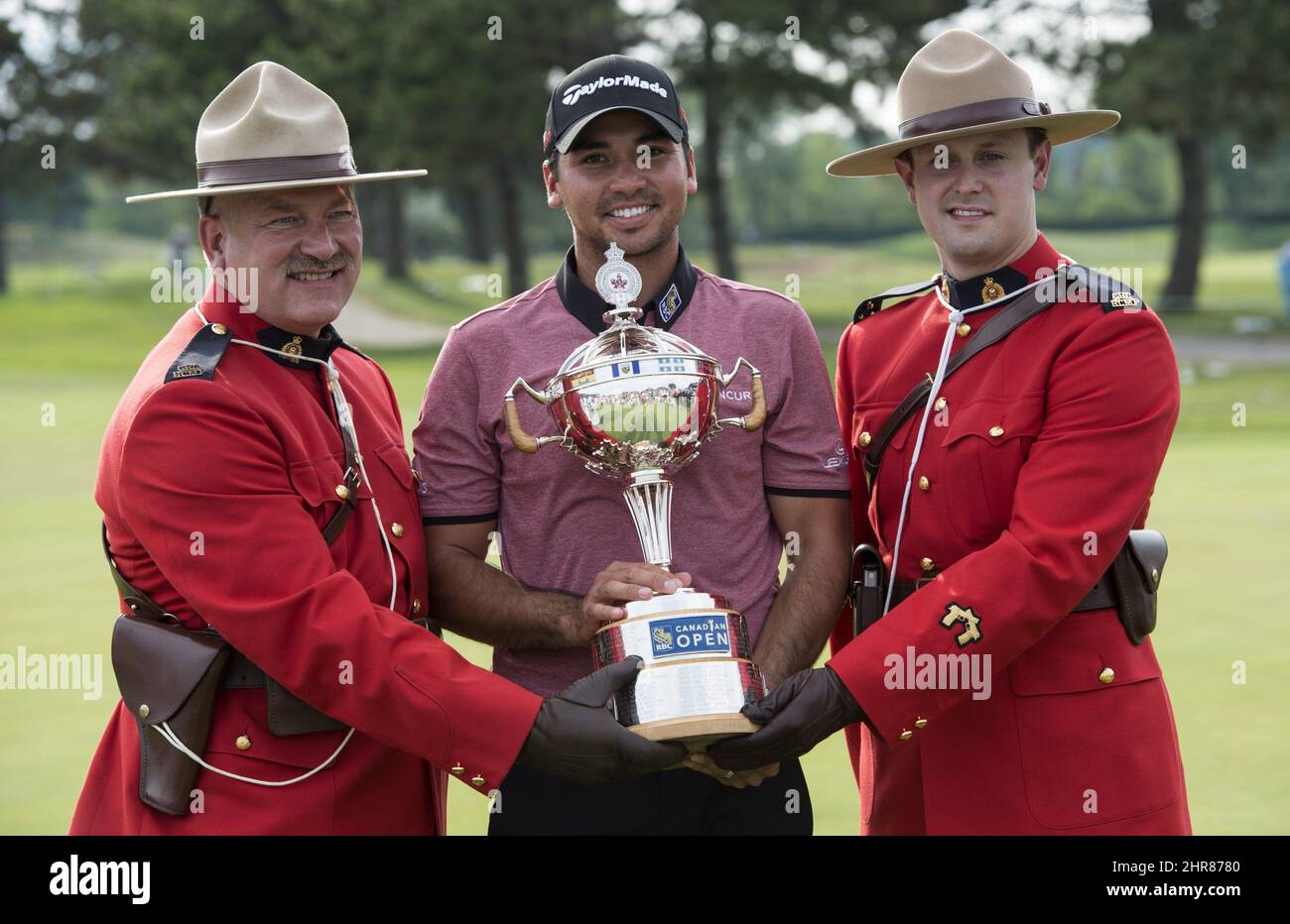Jason Day from Australia holds up the trophy with the help of members ...