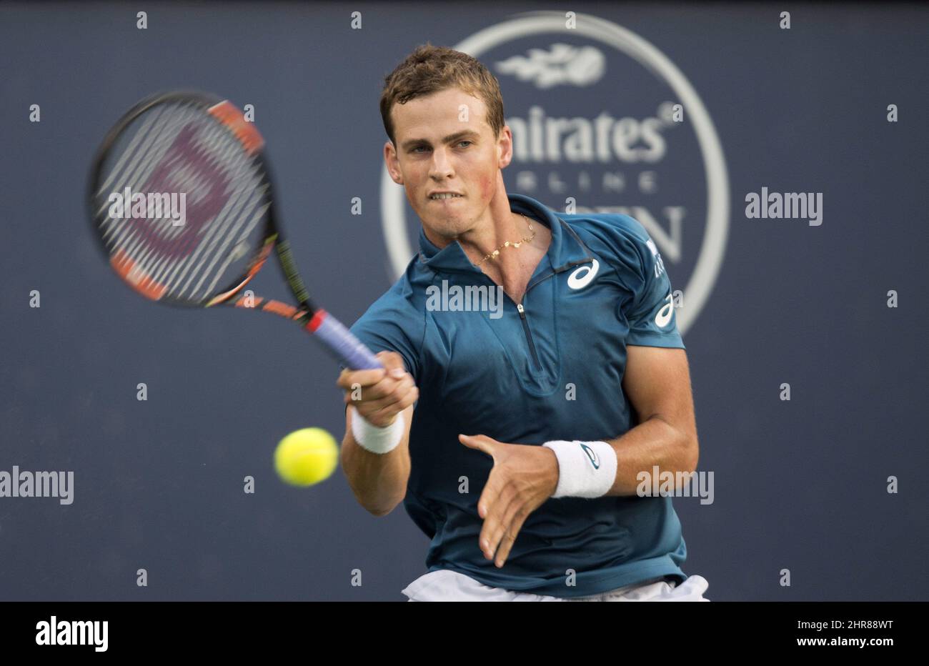 Canada's Vasek Pospisil returns to John Isner of the US during second ...