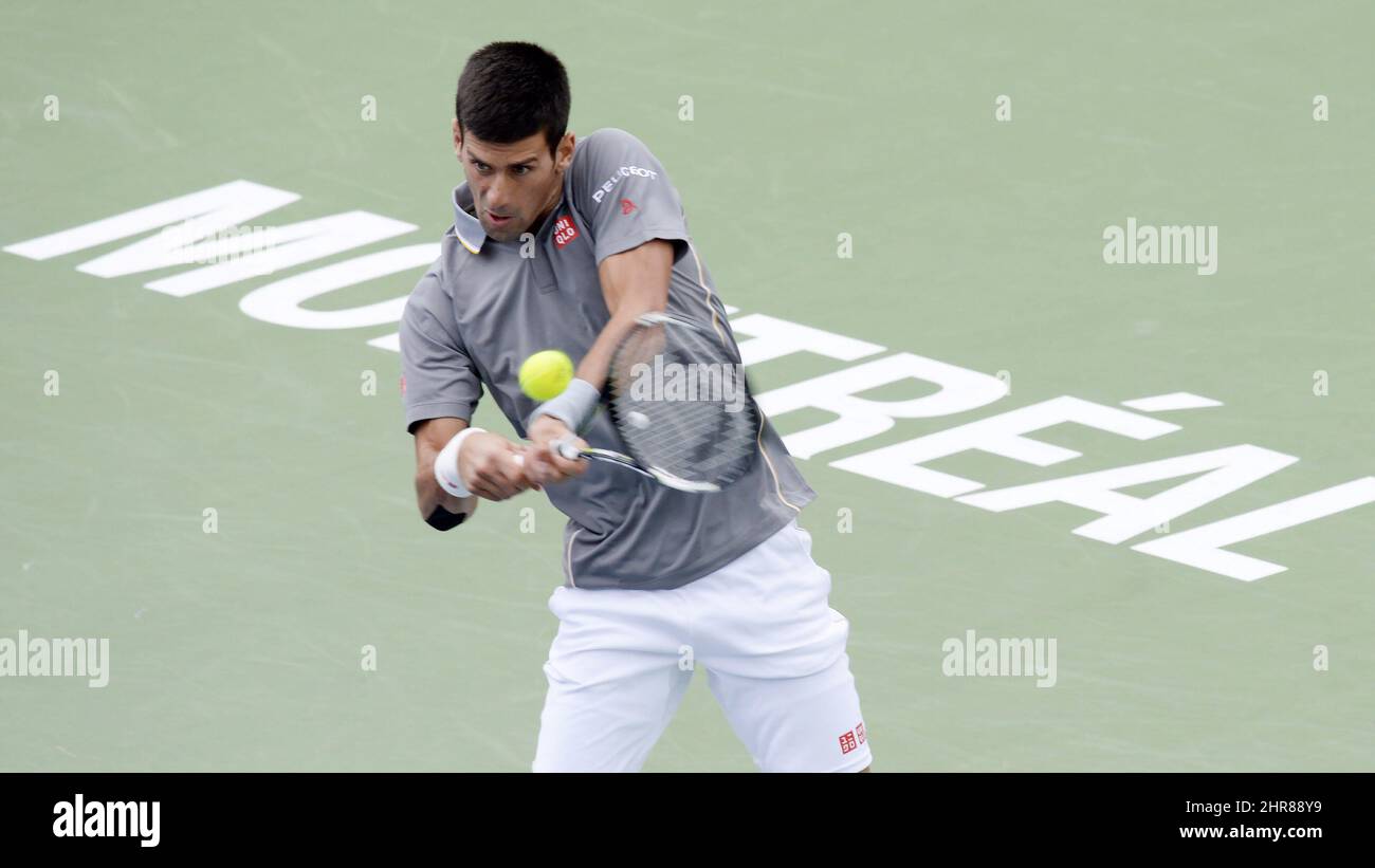 Novak Djokovic, of Serbia, hits a return to Jack Sock, of the United ...