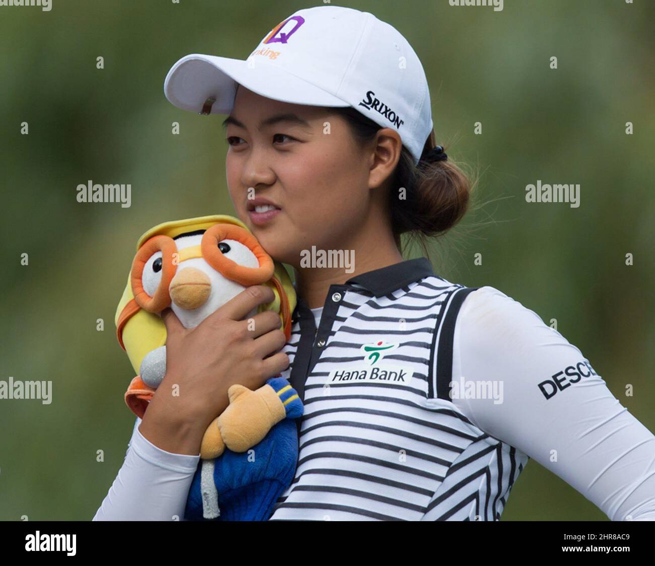 Minjee Lee, of Australia, holds a golf club head cover as she waits to ...