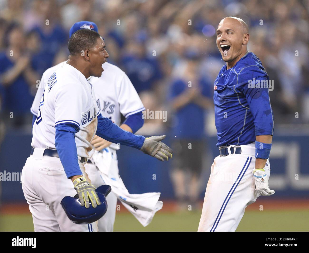 Toronto Blue Jays' Ryan Goins, right, celebrates his walk off home run ...